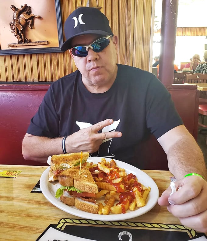 Every great meal comes with a story, and this diner patron's enthusiastic gesture suggests his sandwich is writing an epic.