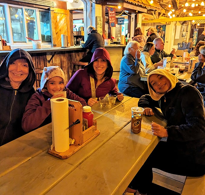 Happy diners bundled up on a cooler evening—proof that great seafood is worth braving any weather.