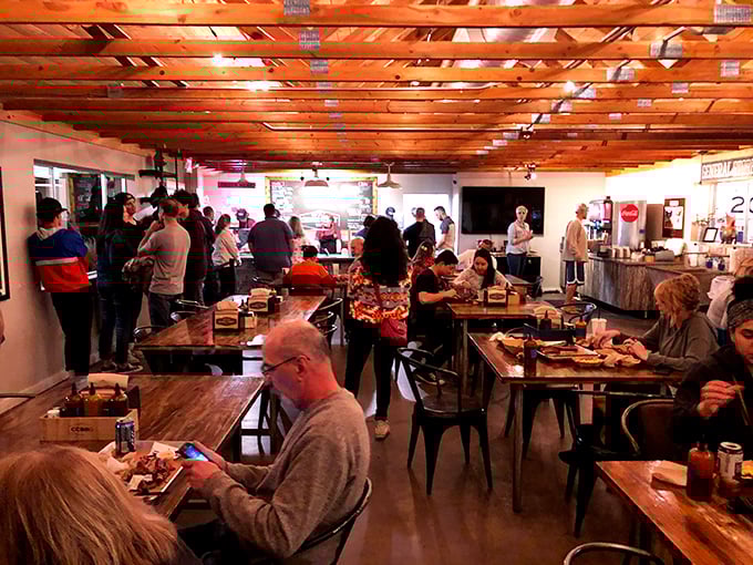 The dining room hums with the universal language of BBQ appreciation. Strangers connected by the shared experience of sauce-stained fingers.