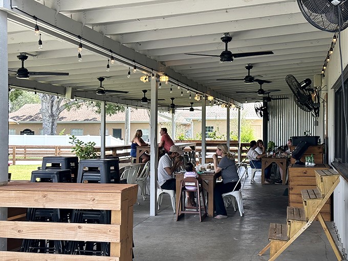 The covered patio where strangers become friends over shared appreciation of biscuits and the Florida breeze.