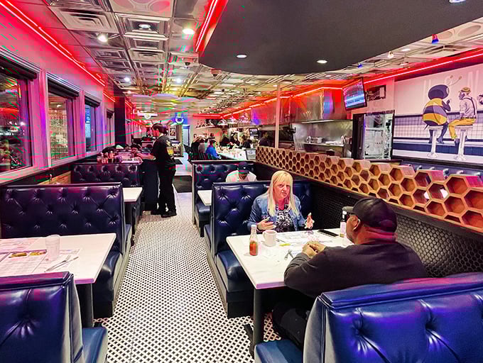 Where strangers become neighbors and calories don't count—the diner's blue booths and honeycomb walls create the perfect backdrop for life's conversations.