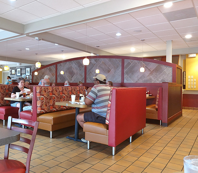 The booth section—where strangers become neighbors and neighbors become friends over plates of eggs and endless coffee refills.