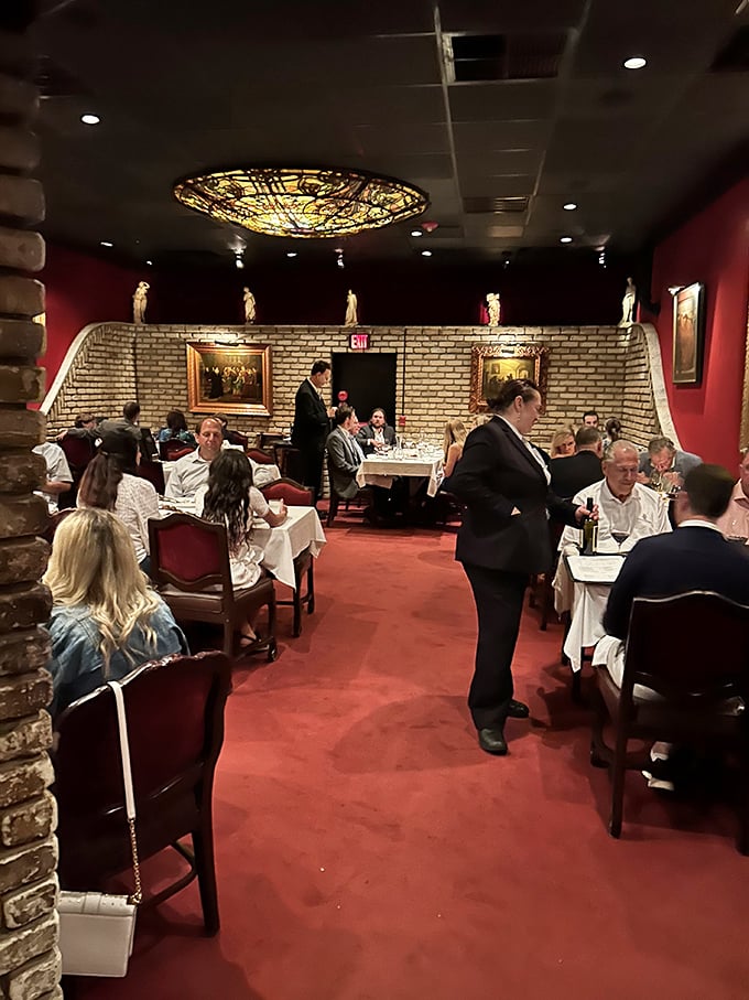 The dining room hums with the symphony of fine dining – servers in tuxedos gliding between tables like Fred Astaire in a kitchen.