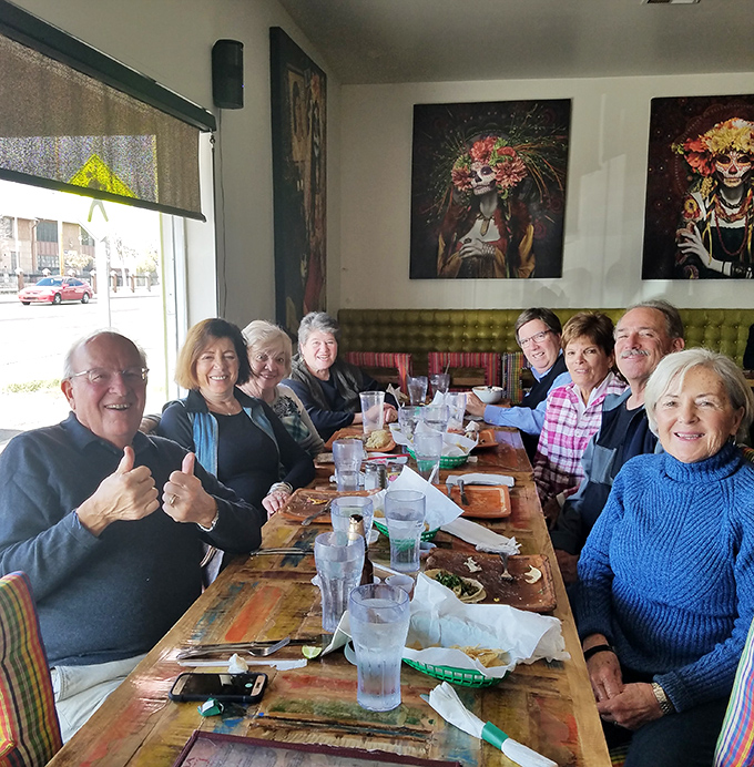The universal language of good food: happy diners giving thumbs up. When the tacos are this good, strangers become temporary family.