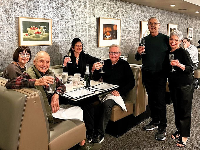 A gathering of regulars raising glasses in that familiar booth – the true measure of a neighborhood restaurant's success isn't stars, but loyalty.