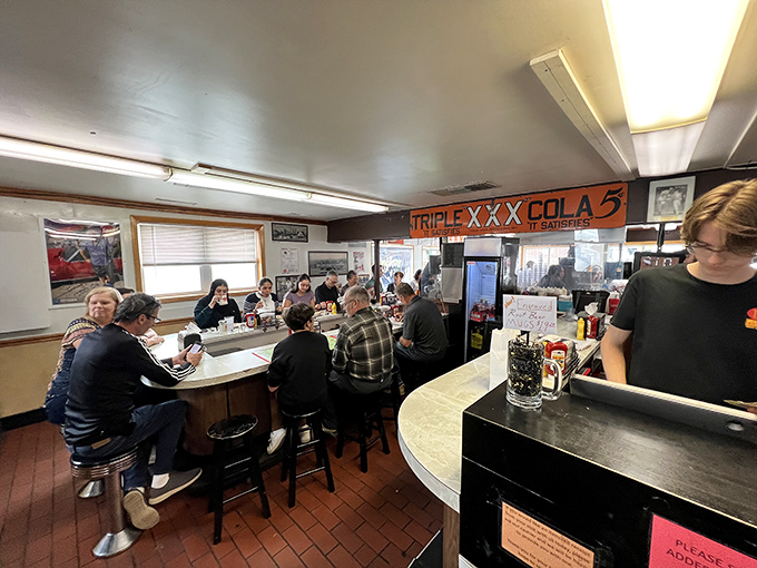 The counter at Triple XXX isn't just seating—it's front row tickets to the greatest show in West Lafayette: community happening over comfort food.