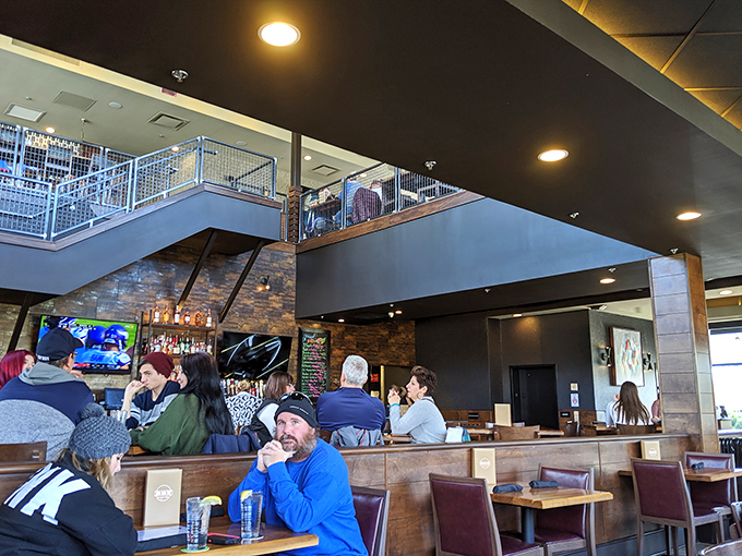 The multi-level dining space buzzes with conversation and clinking glasses—proof that good food brings people together better than any social media platform.