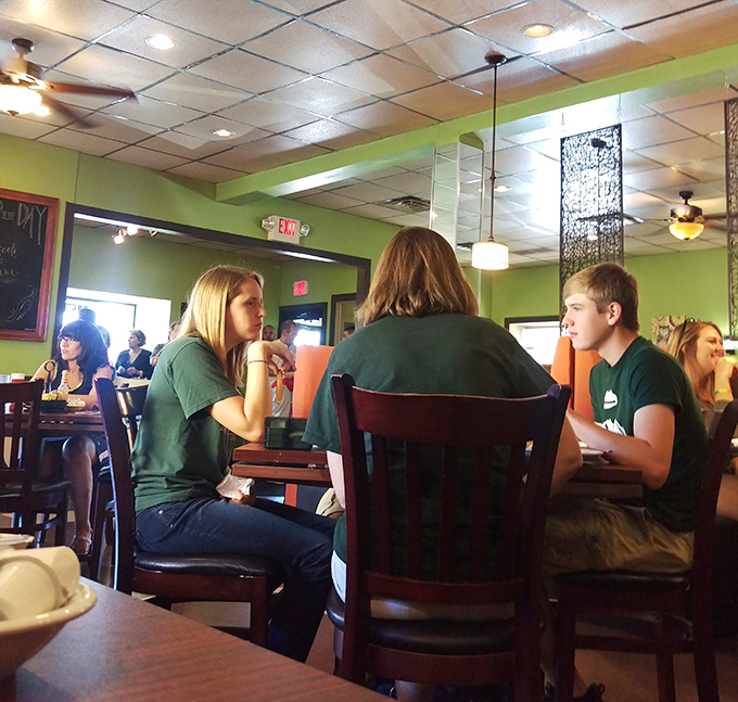 The breakfast buzz in full swing—where strangers become friends united by the universal language of "pass the syrup, please."