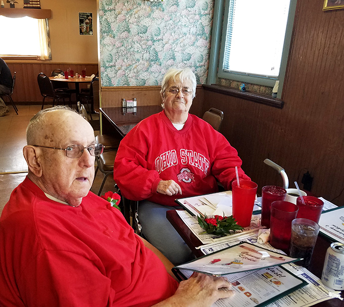 The true heart of any great diner—loyal regulars who've turned their favorite booth into a second living room, complete with Ohio State pride.