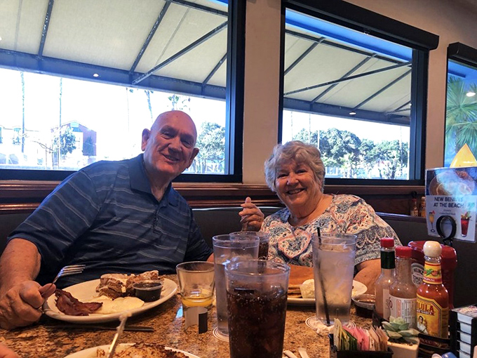 Happy diners sharing stories over plates that will soon be spotless – the universal language of good food bringing people together.