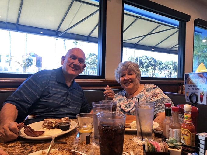 Happy diners sharing stories over plates that will soon be spotless – the universal language of good food bringing people together.