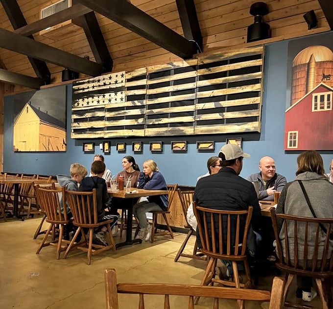 The rustic Americana décor featuring barn murals and a wooden flag creates the perfect setting for families to gather around barbecue bounty.