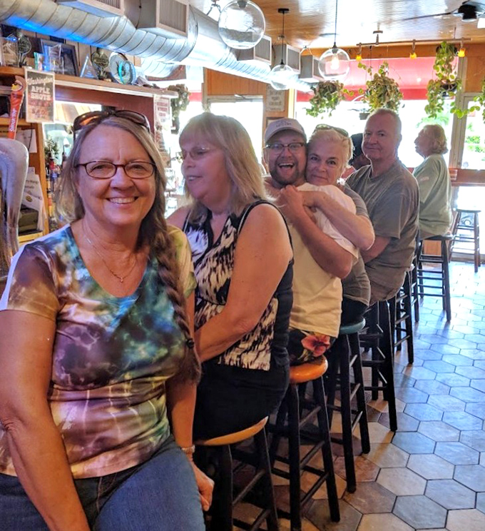 Happy customers lined up at the bar, proving that good seafood creates instant friendships and permanent memories.