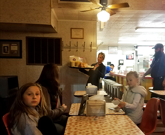 The dining room buzzes with the universal language of satisfaction. Notice how nobody's looking at their phones—they're too busy experiencing actual joy.