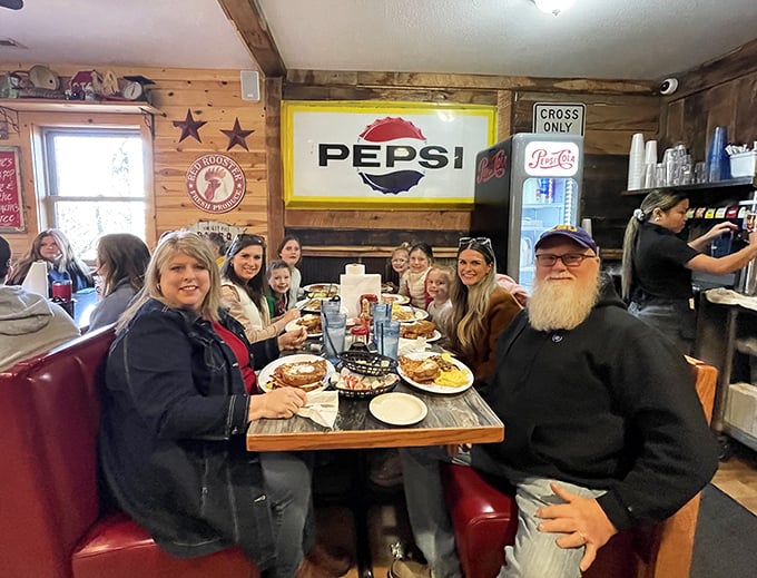 Happy diners sharing the communal joy of excessive breakfast portions. Notice how nobody's checking their phones—the food demands full attention.