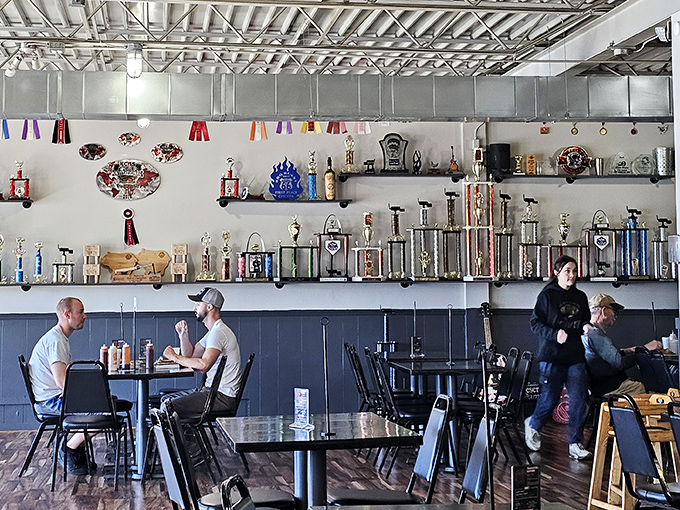 The wall of trophies tells you everything you need to know—these folks aren't just making barbecue, they're creating award-winning masterpieces that keep the competition sweating.