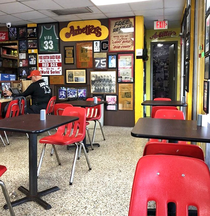The dining area—where sports memorabilia and decades of local history create the perfect backdrop for hot dog enlightenment.