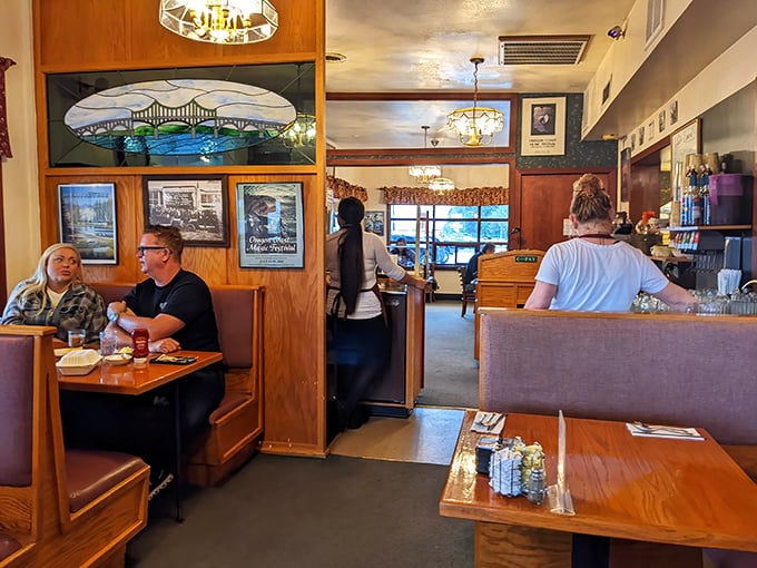 Classic diner booths where countless conversations have unfolded over coffee refills. Note the stained glass window—unexpected elegance in a no-frills setting.