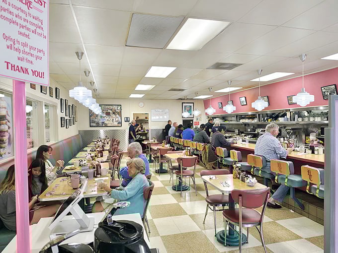 The classic diner interior with its pink walls, pendant lights, and checkered floor isn't retro by design—it's authentic by survival.