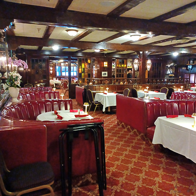 Red leather booths and white tablecloths create that perfect balance of elegance and approachability that few restaurants manage to achieve.
