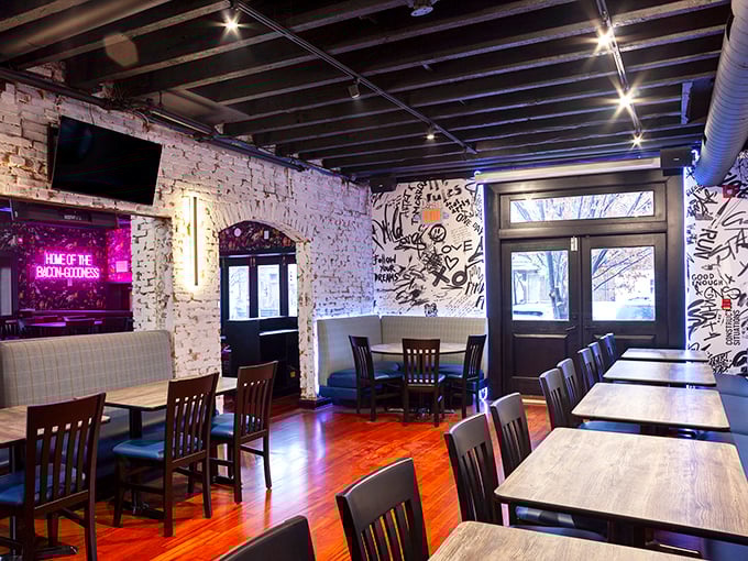 Exposed brick walls that have witnessed countless "first bite" faces. That neon sign isn't just decoration—it's speaking the absolute truth about this place.