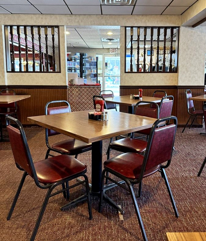 The dining area speaks volumes – simple tables, practical chairs, and dividers that say, "We've been doing this right since before you were born."