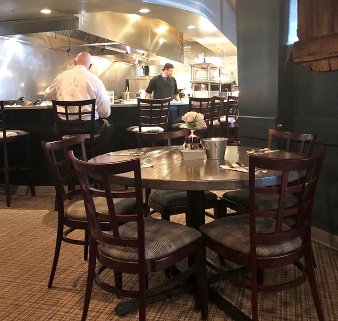 The open kitchen design isn't just trendy—it's an honest invitation to witness the magic happening behind your meal.