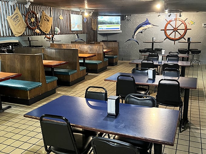 The dining area waits for the day's seafood pilgrims—wooden booths, nautical wheels, and zero pretension. Just how a real seafood joint should be.
