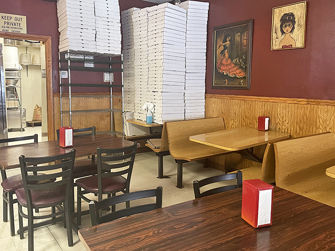 The dining room's tower of pizza boxes stands like a cardboard Leaning Tower of Pisa—a testament to just how many people need "fixing up" daily.
