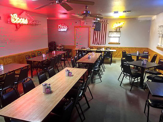 The dining room waits patiently for the lunch rush, like a theater before the show. Those neon beer signs aren't decoration—they're beacons of hope.