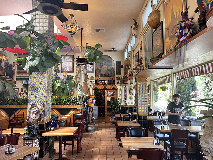 Indiana Jones would approve of this dining room. Artifacts, plants, and colorful tiles create an atmosphere where every meal feels like an expedition.