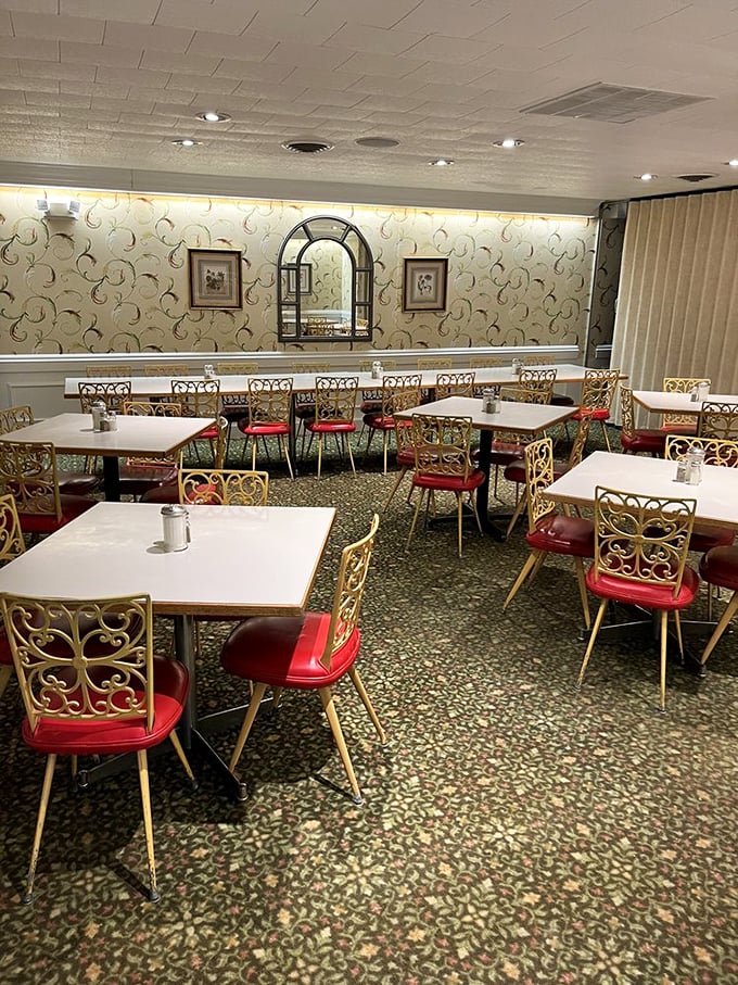 The dining room's vintage charm feels like a warm hug – those filigree chairs and patterned carpet have witnessed decades of satisfied sighs.