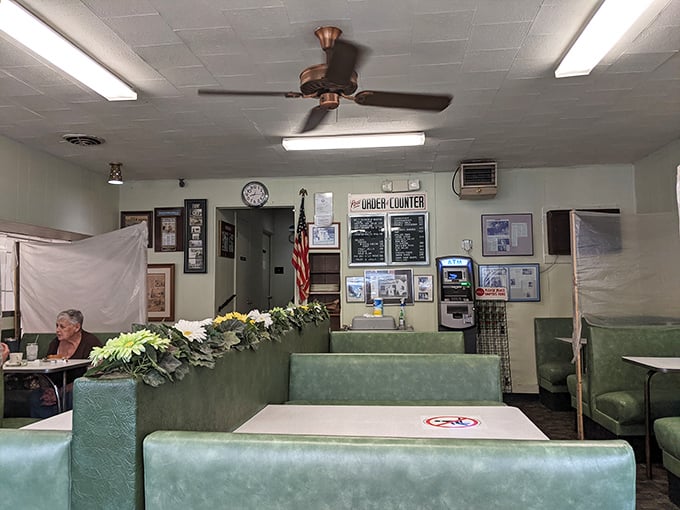 The dining area feels like it's been preserved in amber since the Eisenhower administration, right down to the ceiling fan and American flag—a Norman Rockwell painting come to life.
