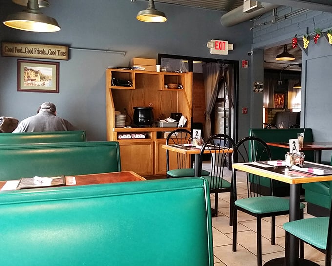Green booth seating that whispers "stay awhile" beneath a sign that perfectly captures Jimmy's philosophy: Good Food, Good Friends, Good Times—the holy trinity of dining.