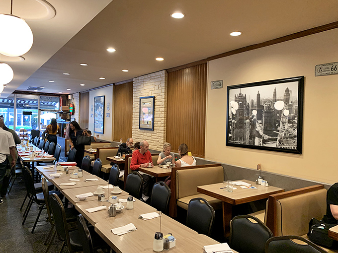 The dining area balances nostalgia with comfort. Those Chicago skyline photos on the wall remind you exactly where this breakfast magic is happening.