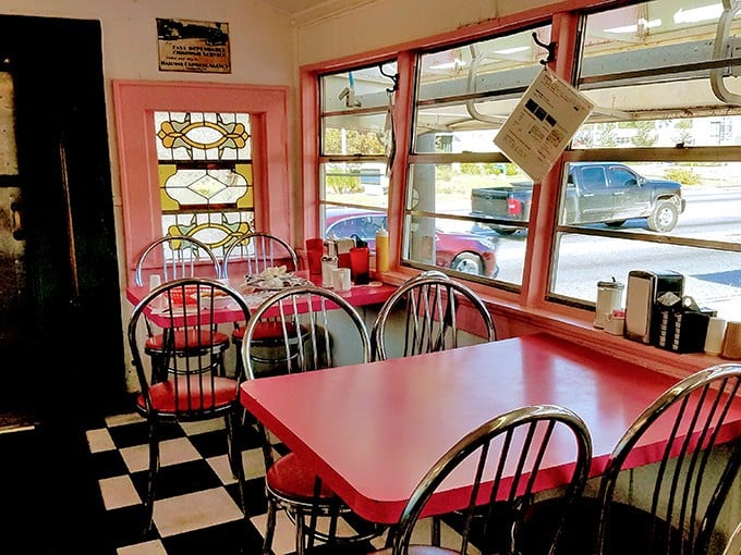 Red tables, chrome chairs, and a checkered floor—the holy trinity of classic diner design. Stained glass windows add unexpected elegance.