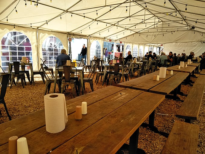 Long wooden tables under a tent create community dining at its finest. Strangers become friends when united by cheese skirts.