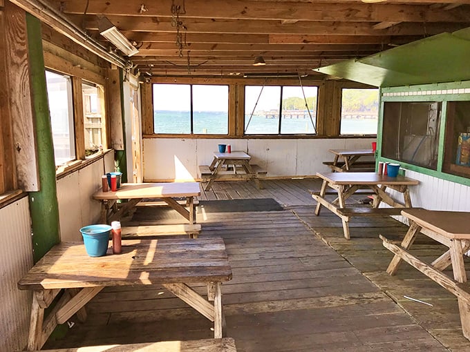 Indoor seating where weathered wood and water views create the perfect backdrop for serious seafood consumption.