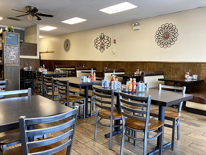 Simple metal chairs and wooden wainscoting create the backdrop for countless morning conversations. No Instagram backdrops needed—just good food and better company.