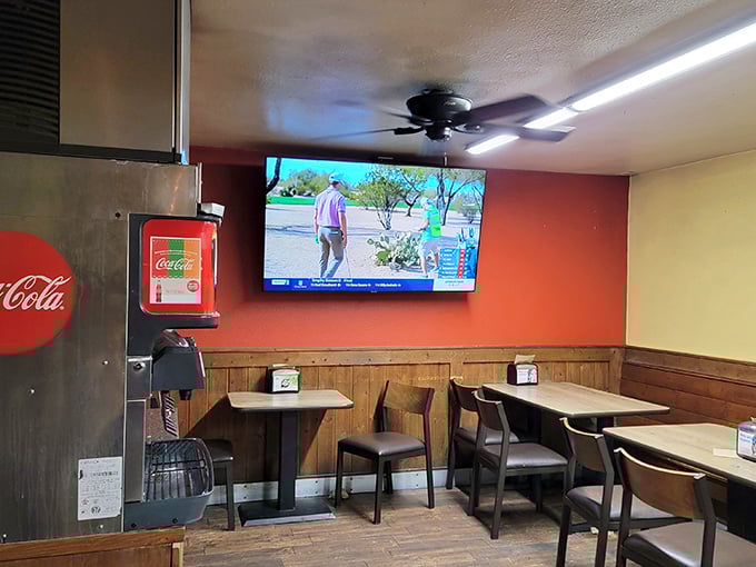 The dining area keeps it simple – wood paneling, comfortable seating, and a TV that nobody's watching because the food demands full attention.