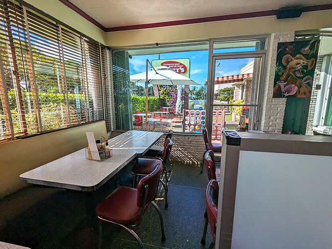 Sunlight streams through vintage blinds, illuminating tables where countless Florida stories have unfolded over countless cups of coffee.