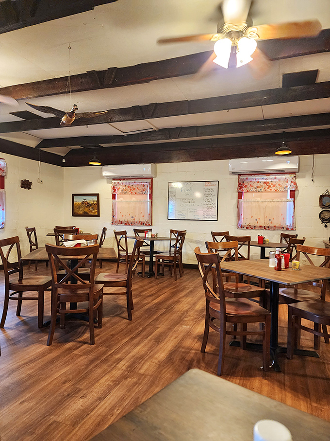 No Edison bulbs or exposed brick here—just honest wooden tables, ceiling fans, and a room designed for the serious business of enjoying good food.
