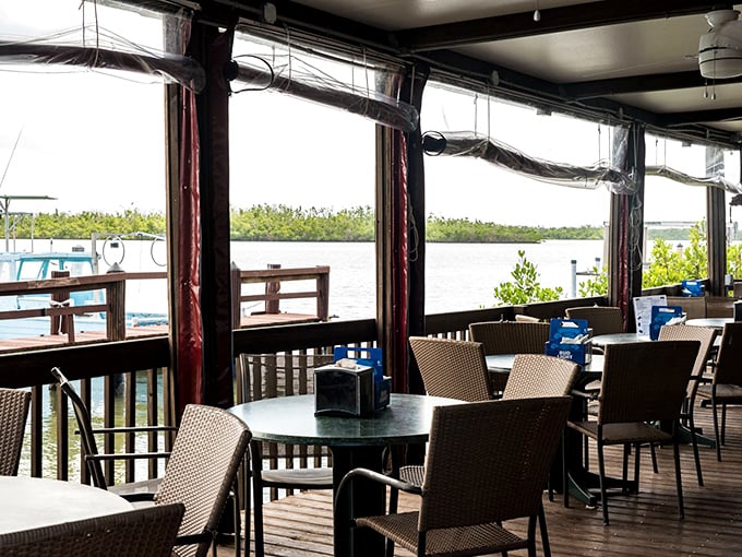 The dining area offers water views that no amount of interior design budget could replicate—Mother Nature showing off while you enjoy your grouper sandwich.