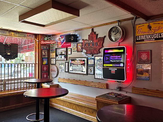 Every inch of wall space tells a story—neon signs and beer memorabilia create the perfect backdrop for serious eating.