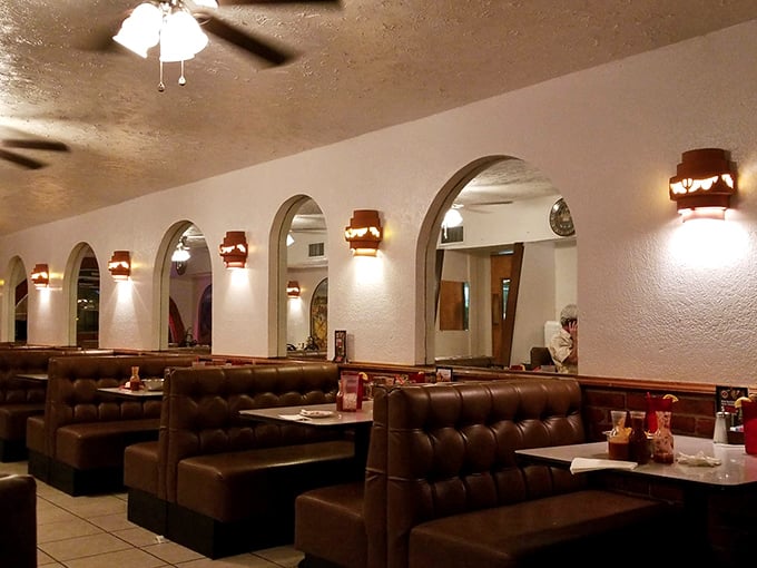Cozy booths, arched doorways, and warm lighting create the perfect backdrop for the age-old tradition of saying "I shouldn't eat another bite" before doing exactly that.