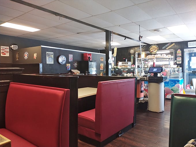 Red vinyl booths that have probably heard more family stories than most therapists, set against walls of automotive memorabilia.