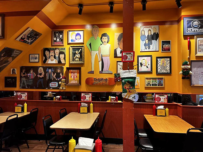 The walls tell stories through pop art and memorabilia while yellow condiment bottles stand ready for duty on each table.