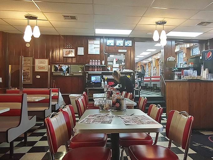 Red vinyl booths and formica tables—the natural habitat of great diner food. Notice how the wood paneling radiates decades of satisfied sighs.