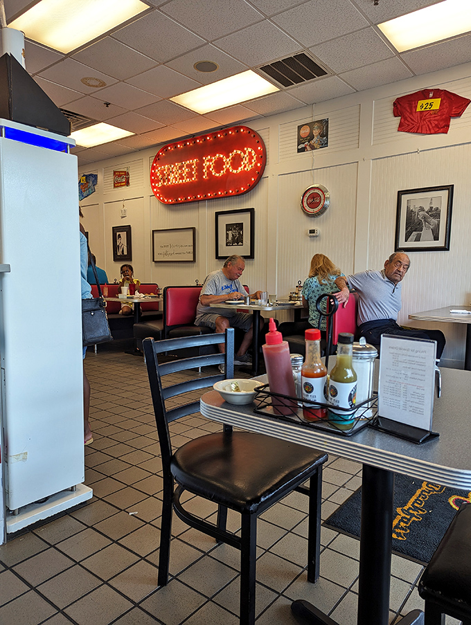 That "GREAT FOOD" sign isn't just decoration – it's truth in advertising. Red booths and condiment caddies create the classic American diner experience.