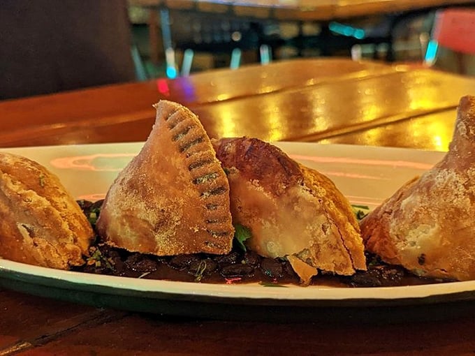 These empanadas look like they've been kissed by the gods of pastry—golden, flaky, and perched atop a bed of savory goodness.